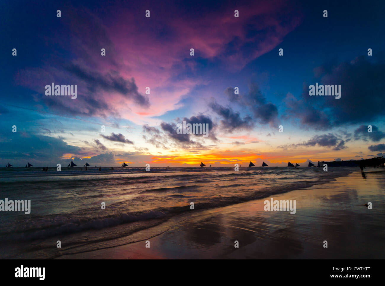 tropical beach with sailing boats at sunset Stock Photo - Alamy
