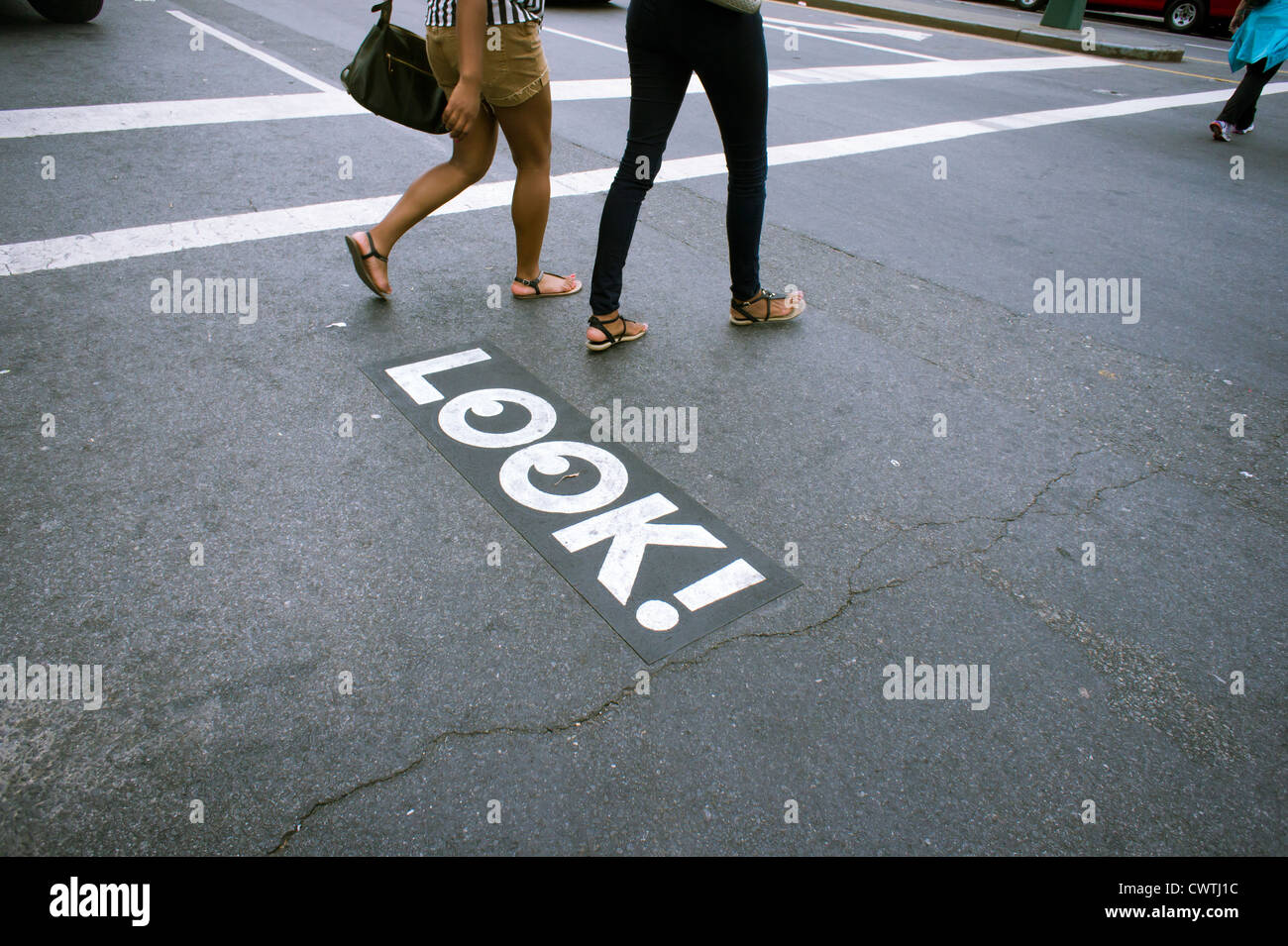 A directional sign at a crossing in New York informs pedestrians of the ...