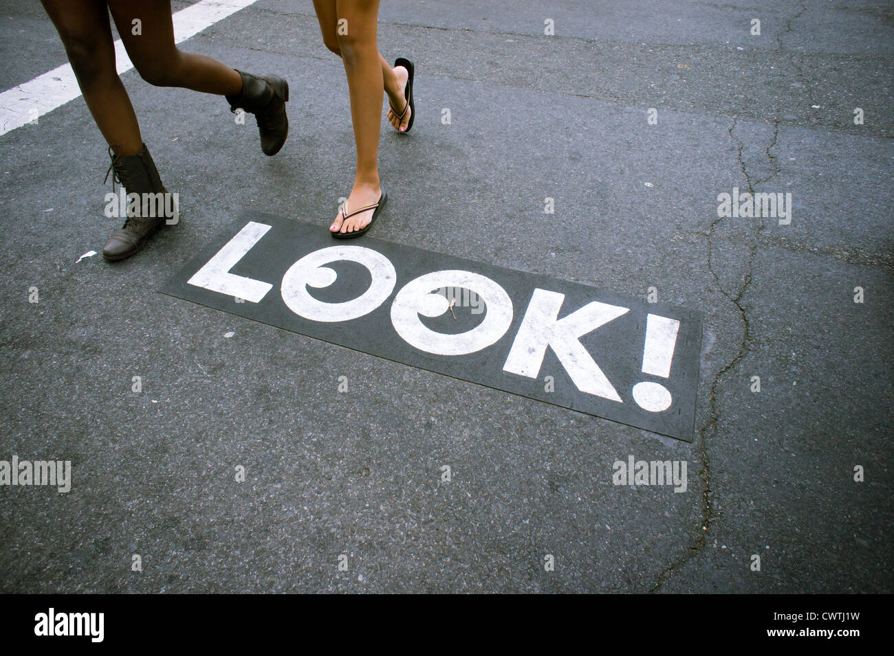 A directional sign at a crossing in New York informs pedestrians of the ...