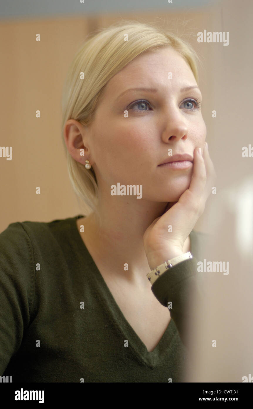 Young woman resting hand at chin Stock Photo - Alamy