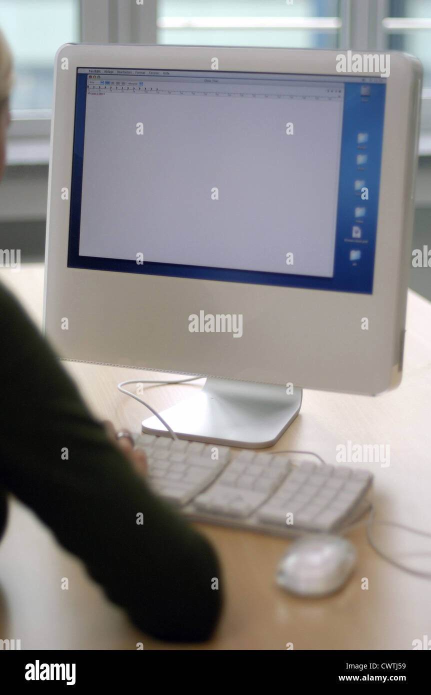 Computer monitor at desk Stock Photo - Alamy