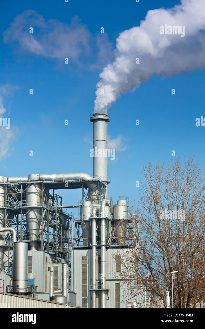 Industrial factory smoke against blue sky background Stock Photo - Alamy