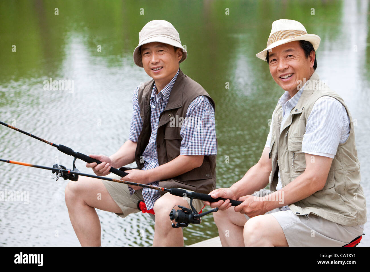 Side view friends fishing hi-res stock photography and images - Alamy