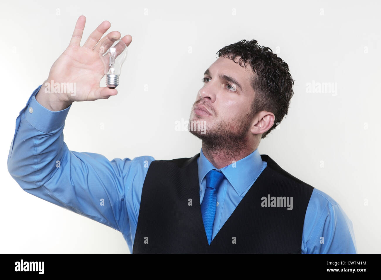 handsome man holding a light bulb in his hand Stock Photo - Alamy