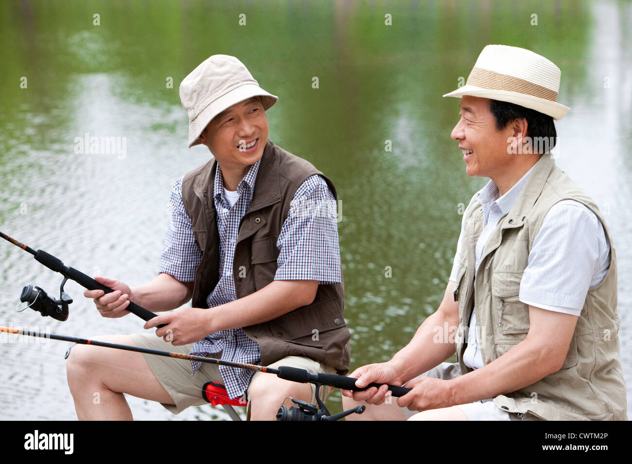 Senior friends fishing together Stock Photo - Alamy