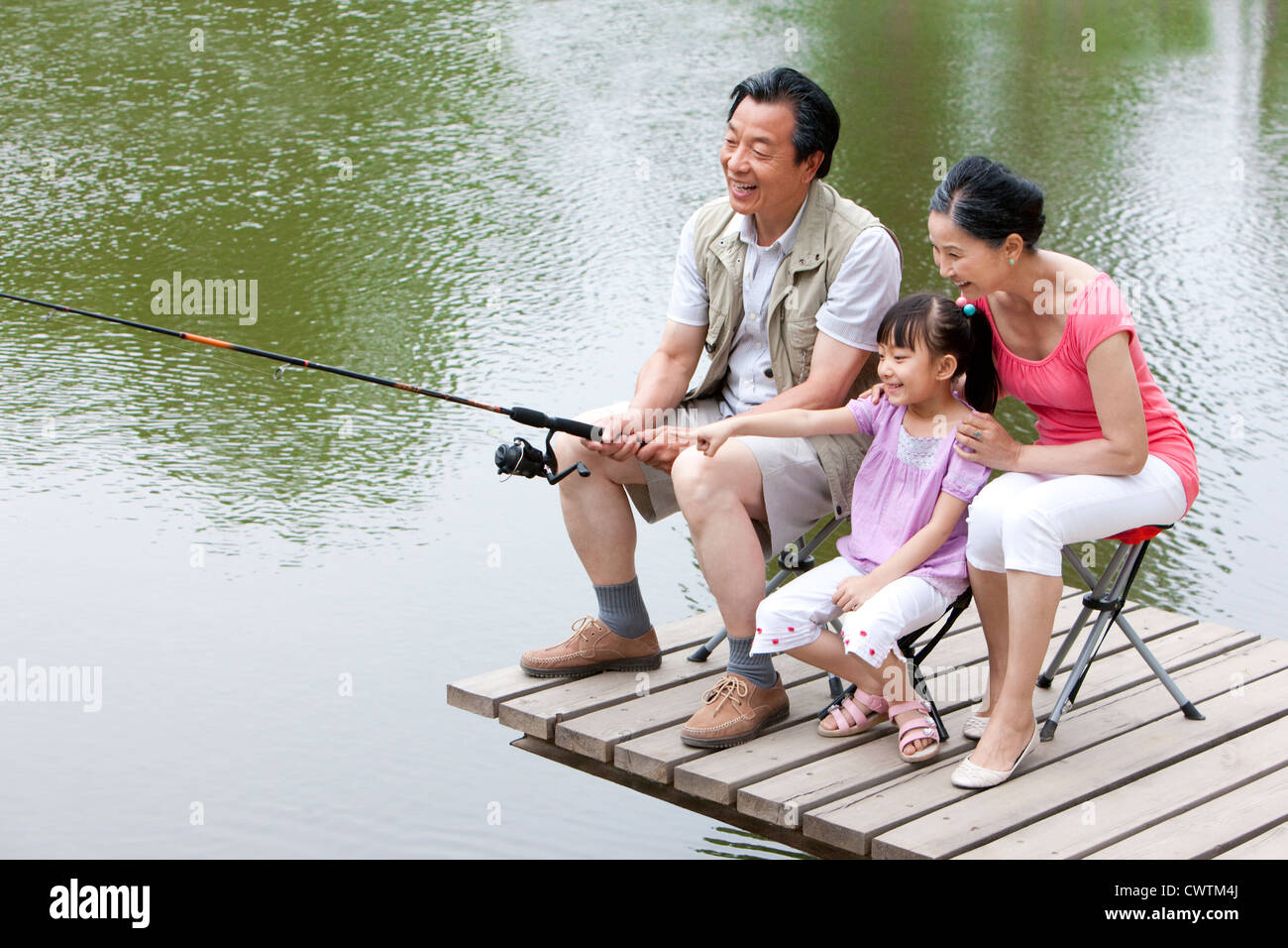 Family Fishing together Stock Photo - Alamy