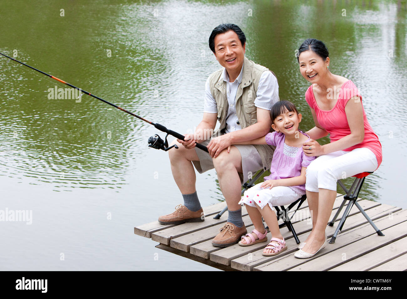 Family Fishing together Stock Photo - Alamy