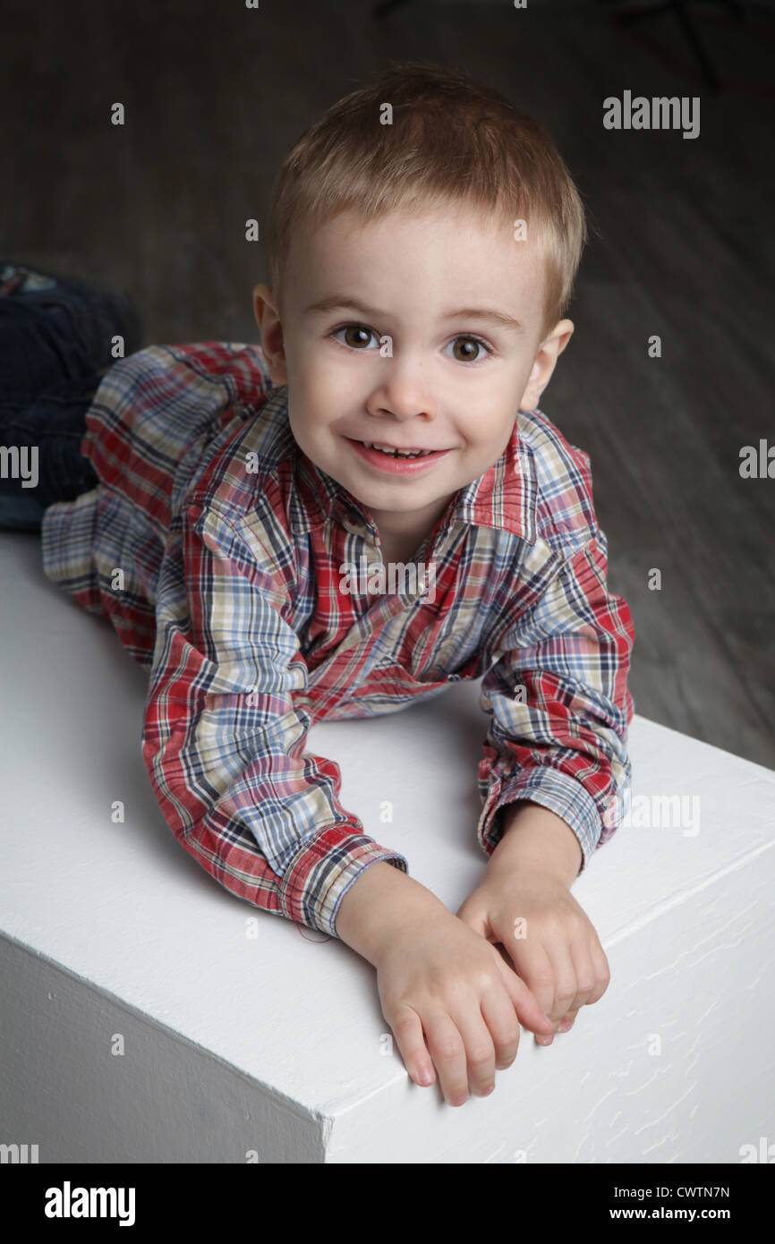 Smiling blond boy wearing checkered shirt Stock Photo - Alamy