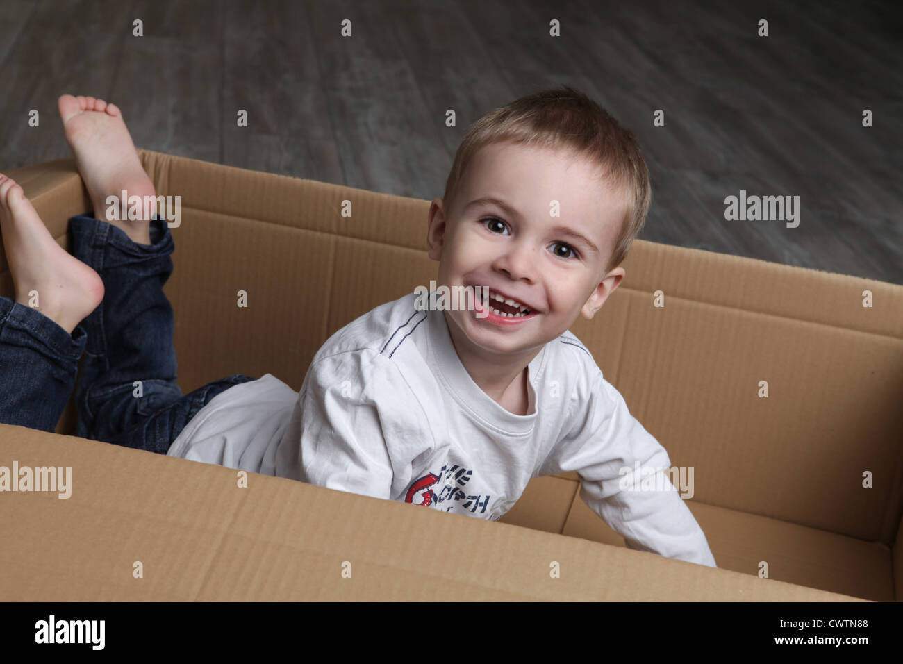 Enthusiastic boy inside cardboard box Stock Photo - Alamy