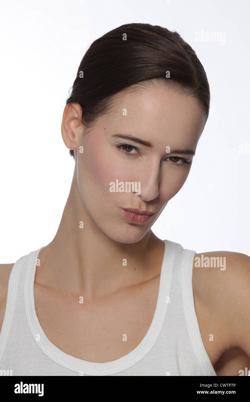 Brunette young woman pouting, portrait Stock Photo - Alamy