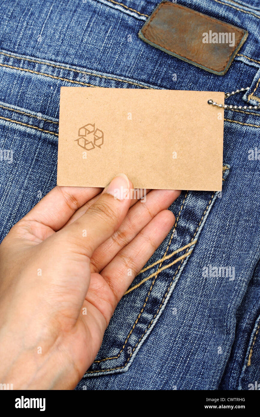 Hand holding price tag over the jean Stock Photo - Alamy