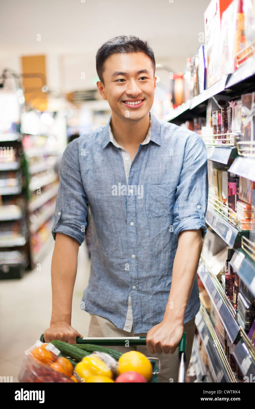Young man shopping in supermarket Stock Photo - Alamy