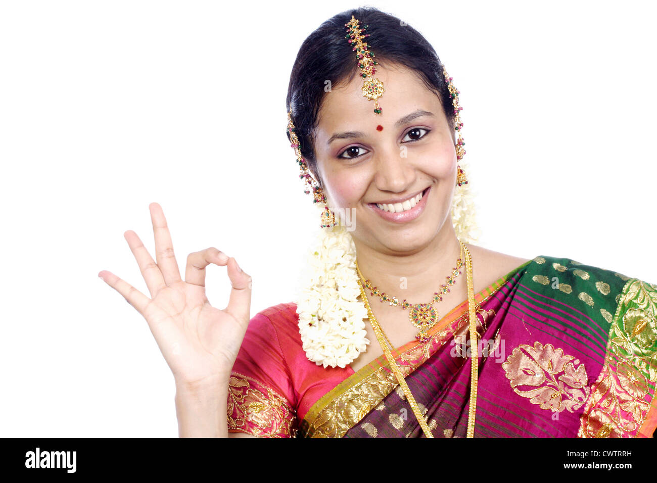 Traditional Indian woman showing OK sign against white Stock Photo - Alamy