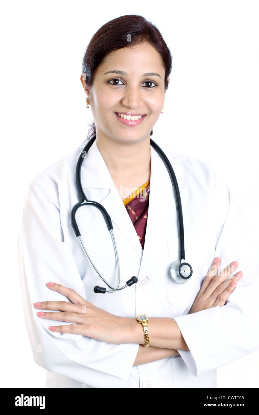 Smiling doctor woman with arms crossed against white background Stock ...