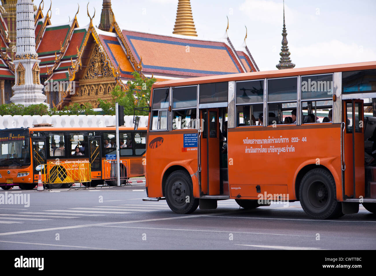 Orange buses and Thai temple, Bangkok Stock Photo - Alamy