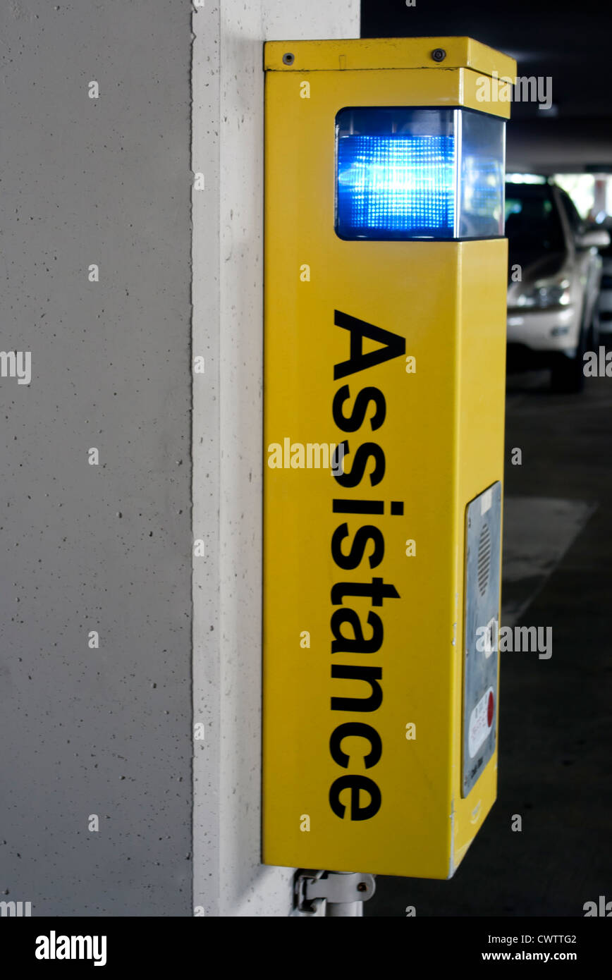 Assistance sign in yellow in garage Stock Photo - Alamy