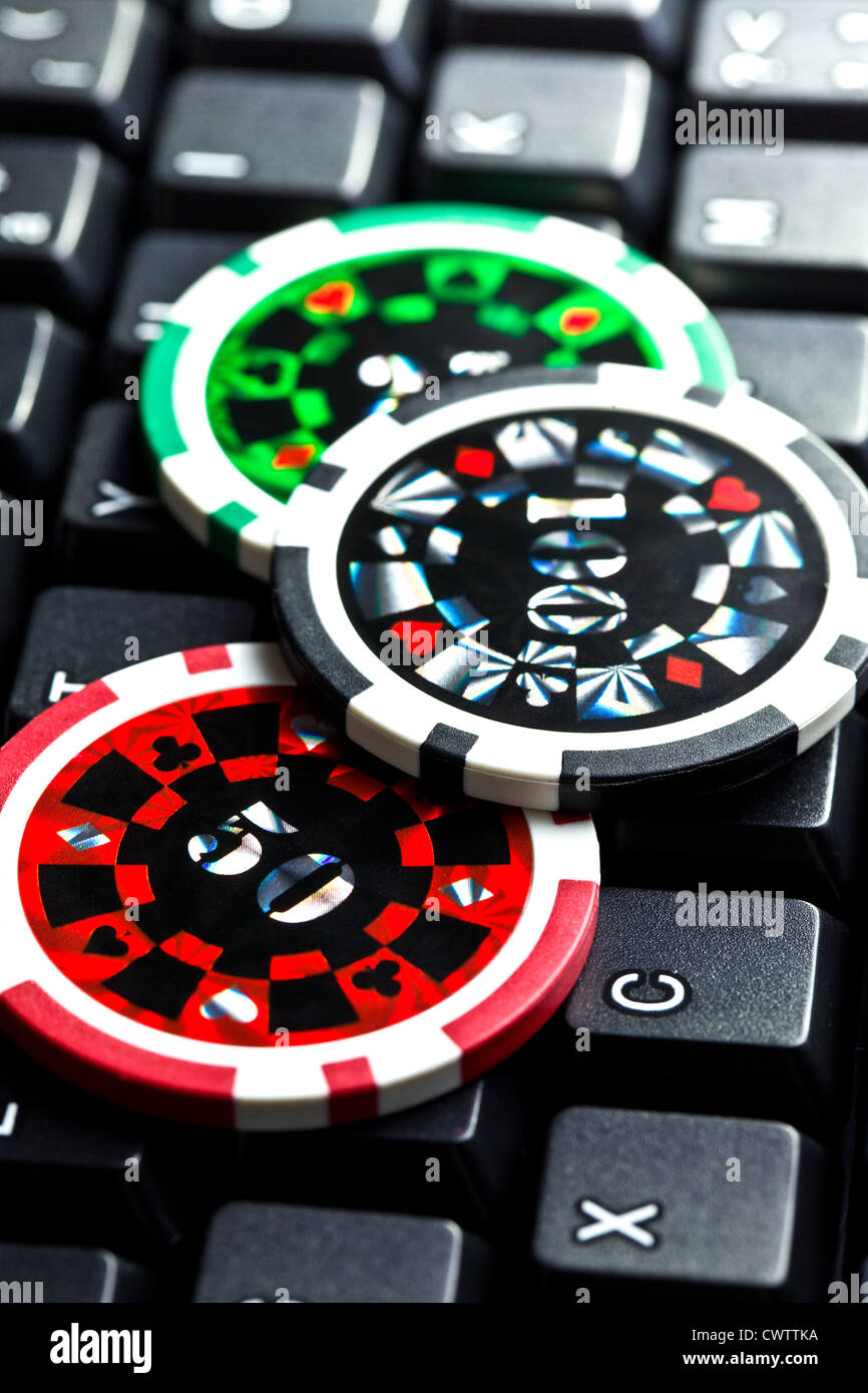 the poker chips on computer keyboard Stock Photo - Alamy