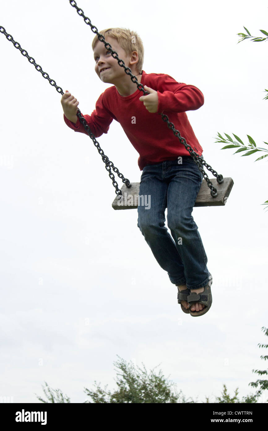 young boy on a swing Stock Photo - Alamy