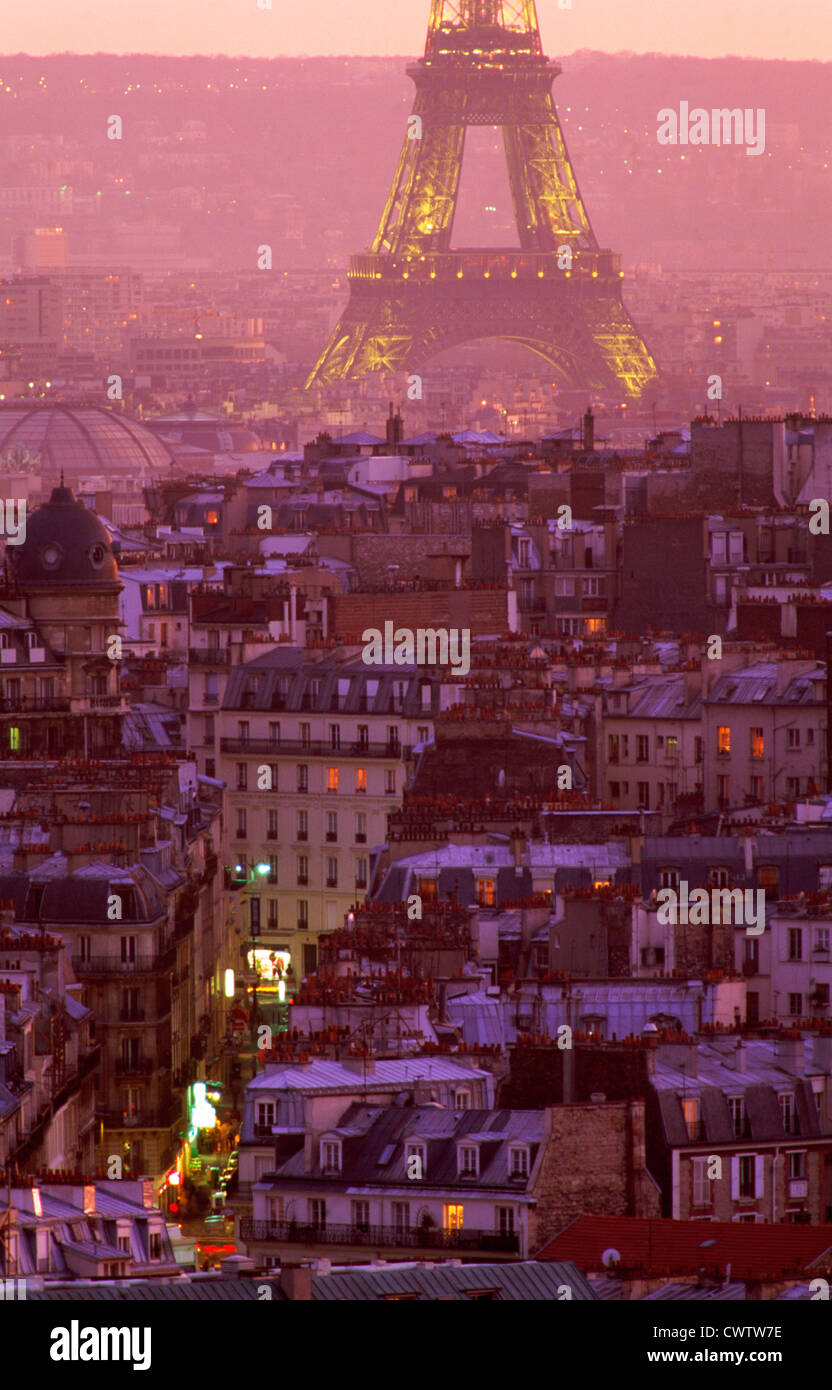 Streets and apartment buildings below Eiffel Tower in Paris at sunset ...