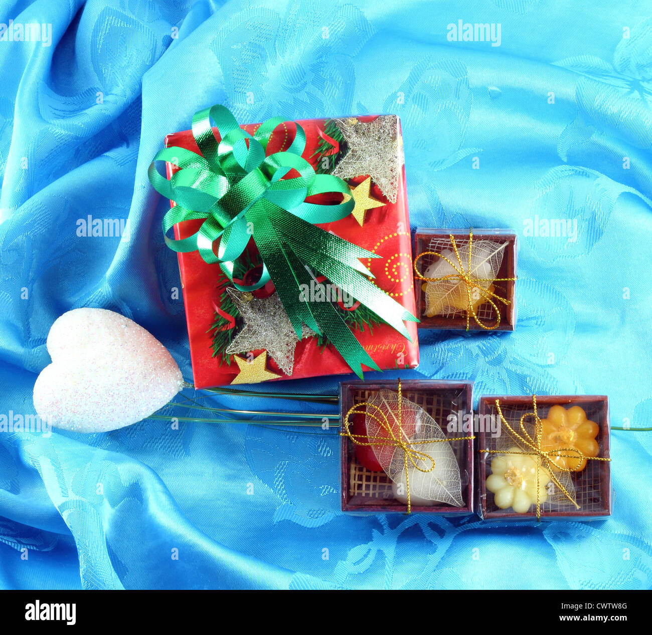 red gift box set with green ribbon on blue satin Stock Photo - Alamy