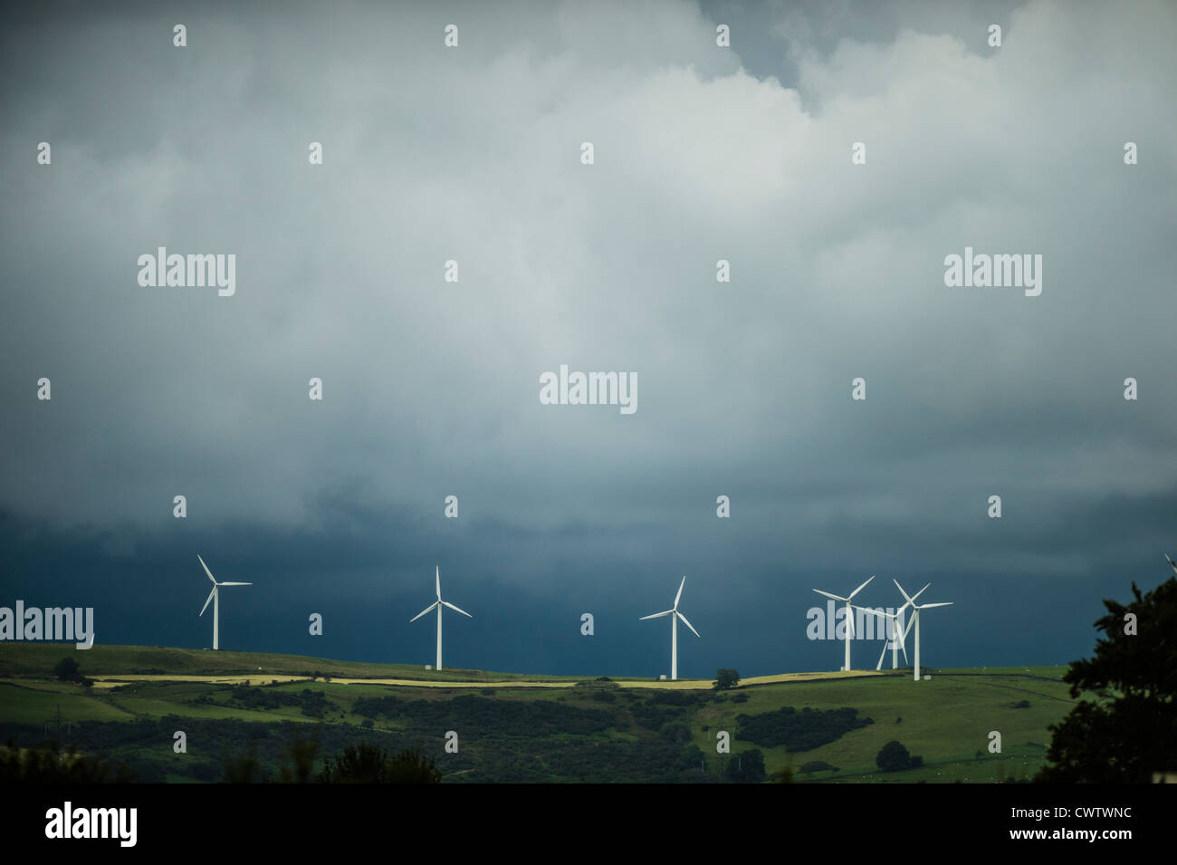 Dark clouds looking over the turbines of a wind farm outside Bridgend ...