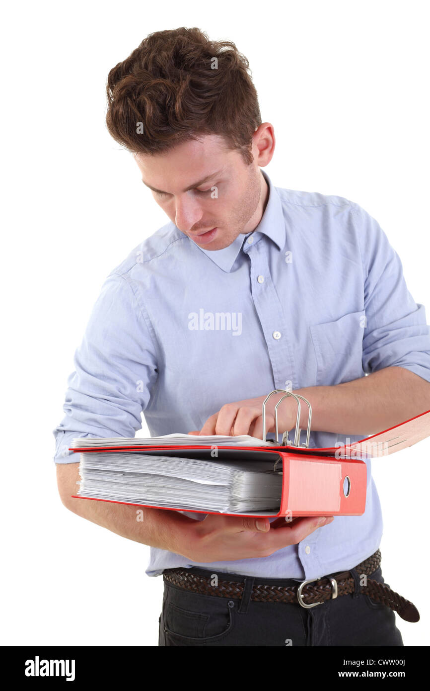 Young man checking documents in folders Stock Photo - Alamy