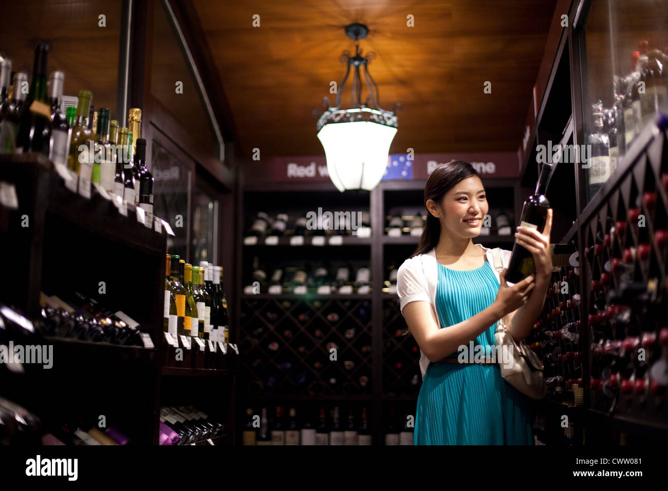 Young woman shopping in cellar Stock Photo - Alamy