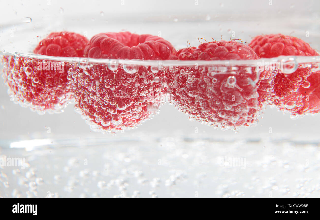 Raspberries in sparkling water Stock Photo - Alamy