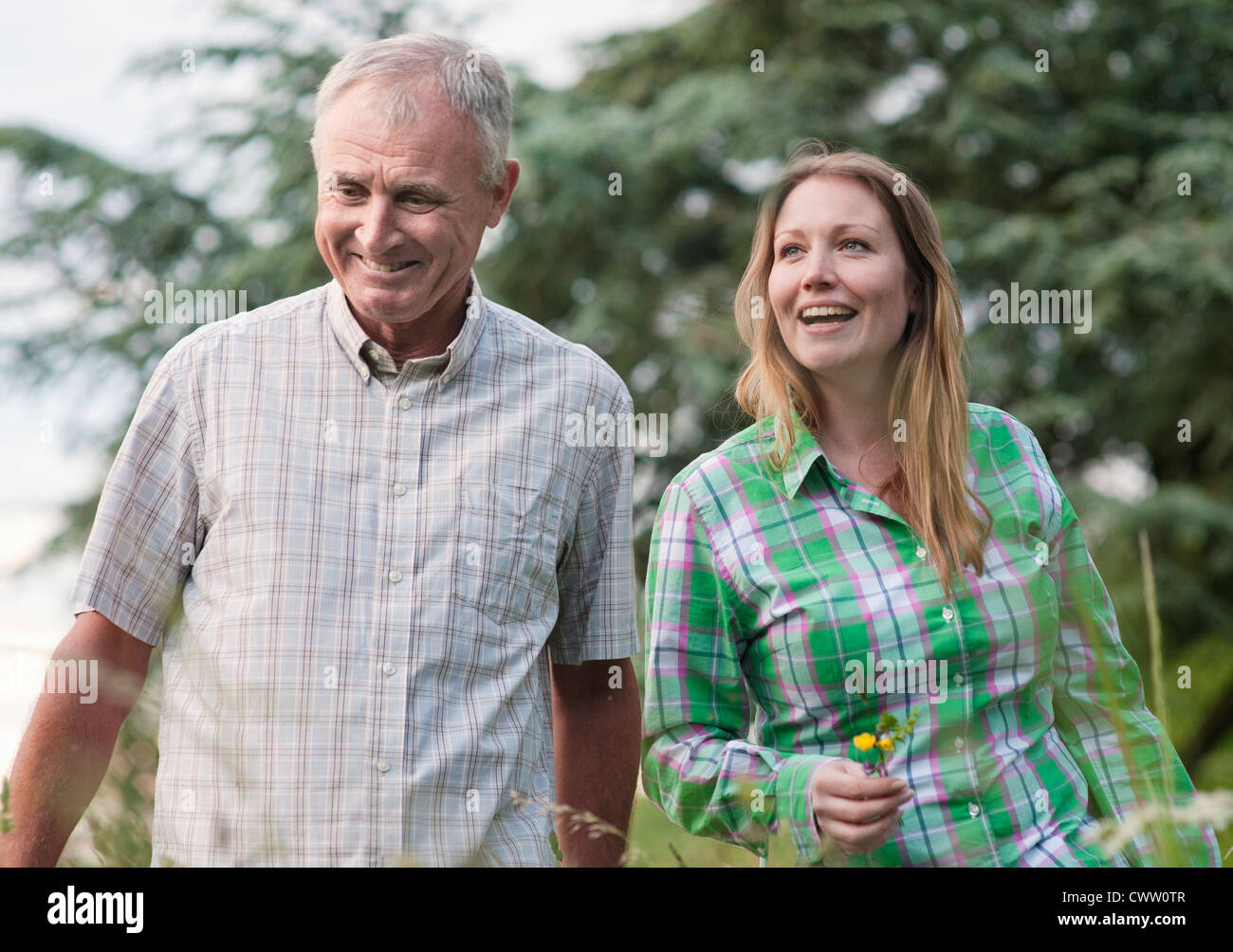 Woman and father walking outdoors Stock Photo - Alamy