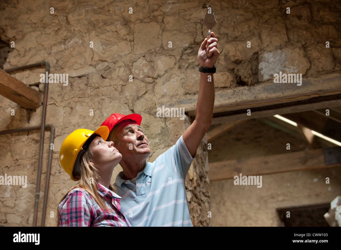 Construction workers examining stone Stock Photo - Alamy