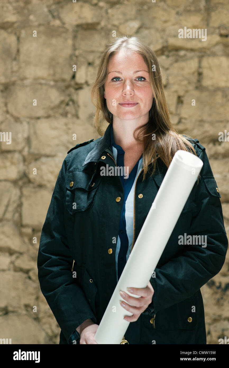 Woman carrying roll of paper indoors Stock Photo - Alamy