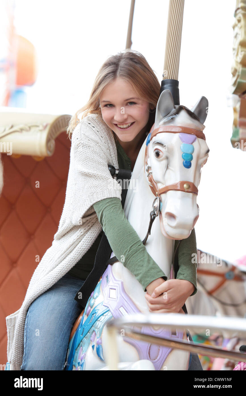 Happy woman on a carousel Stock Photo - Alamy