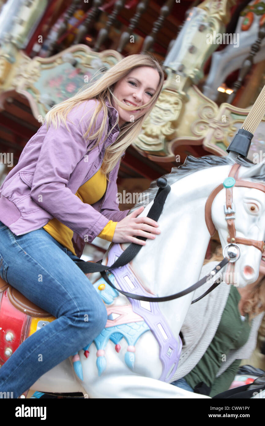 Happy woman on a carousel Stock Photo - Alamy