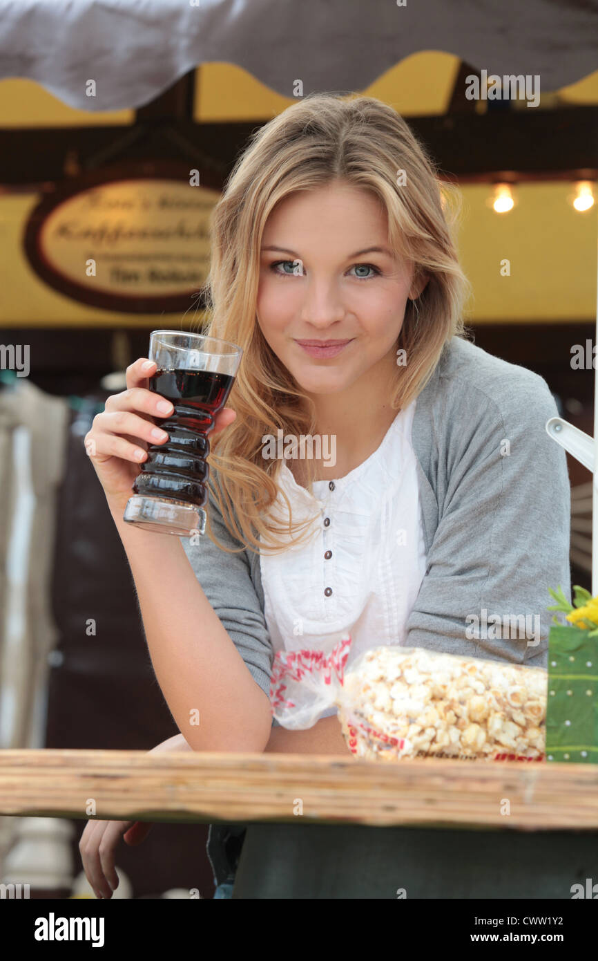 Smiling woman with soft drink on a funfair Stock Photo - Alamy
