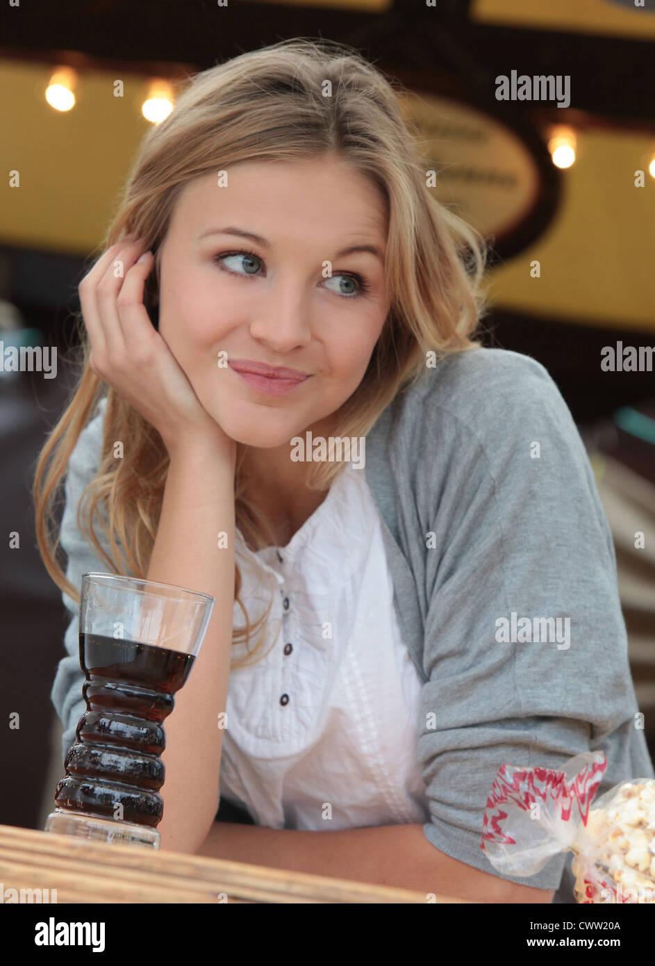 Smiling woman with soft drink on a funfair Stock Photo - Alamy