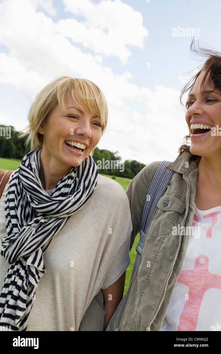 Smiling women walking together outdoors Stock Photo - Alamy
