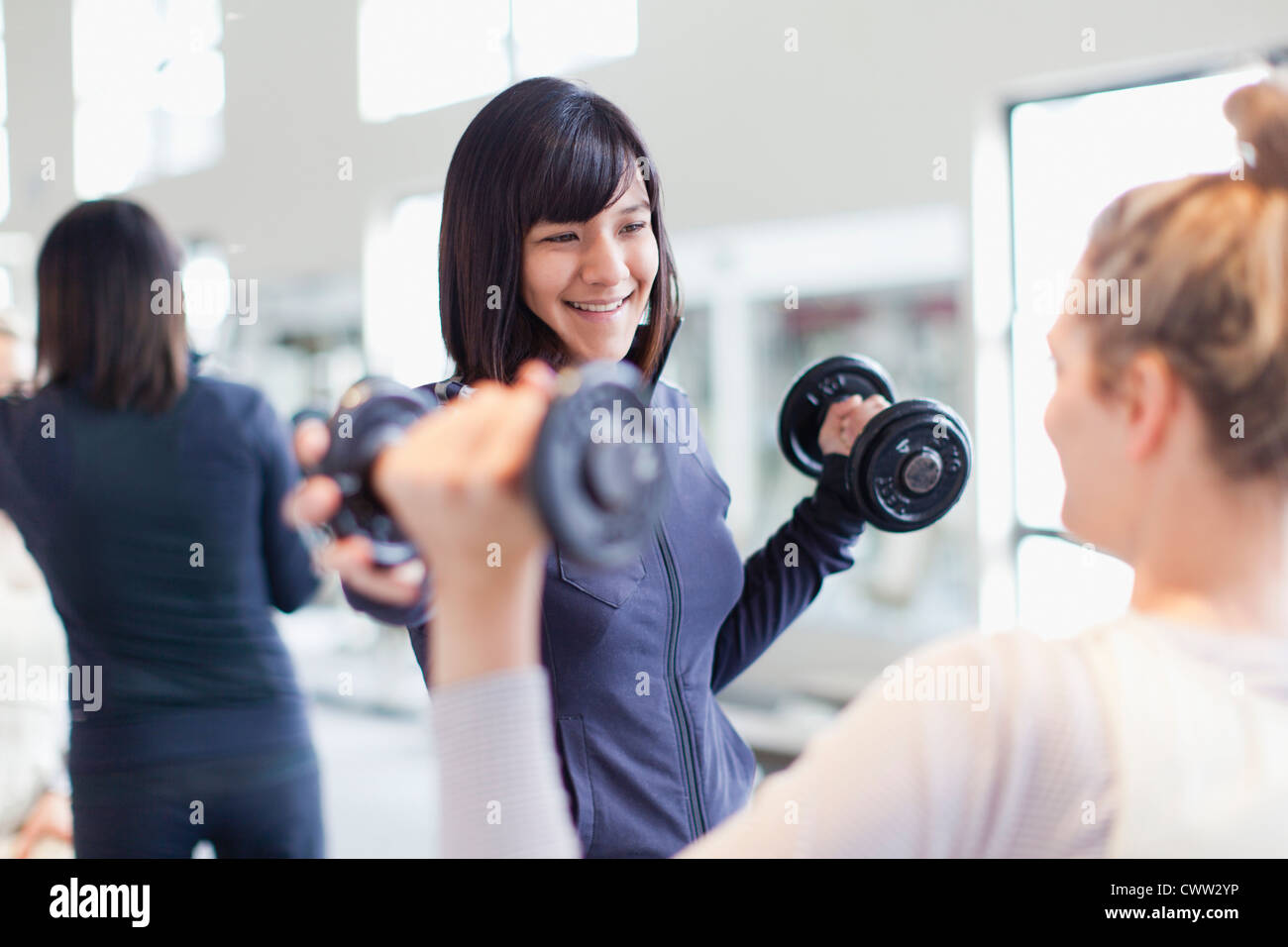 Trainer working with client in gym Stock Photo - Alamy
