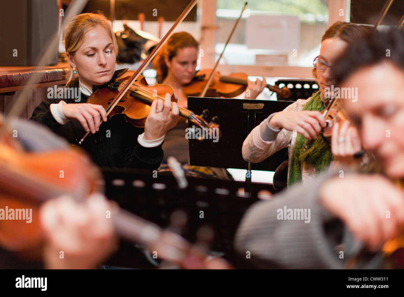 Violin player practicing with group Stock Photo - Alamy