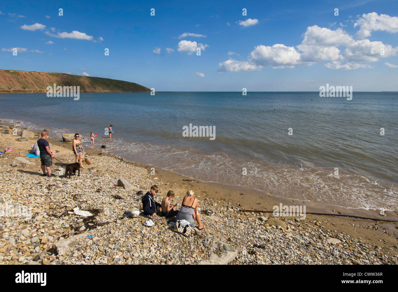 Families at play, Filey Beach. Filey Brigg in background Stock Photo ...
