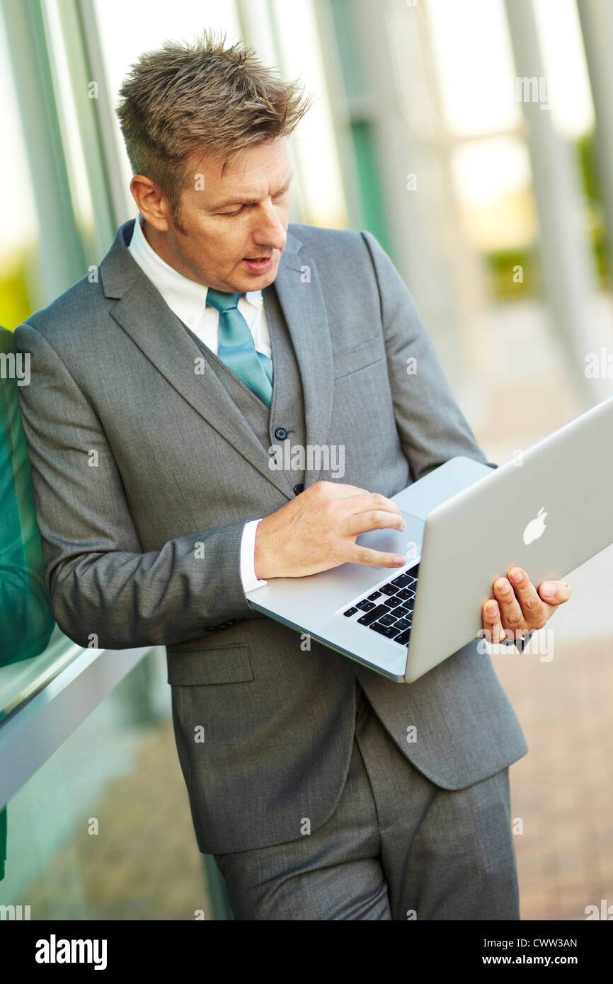 Businessman looking at his laptop Stock Photo - Alamy