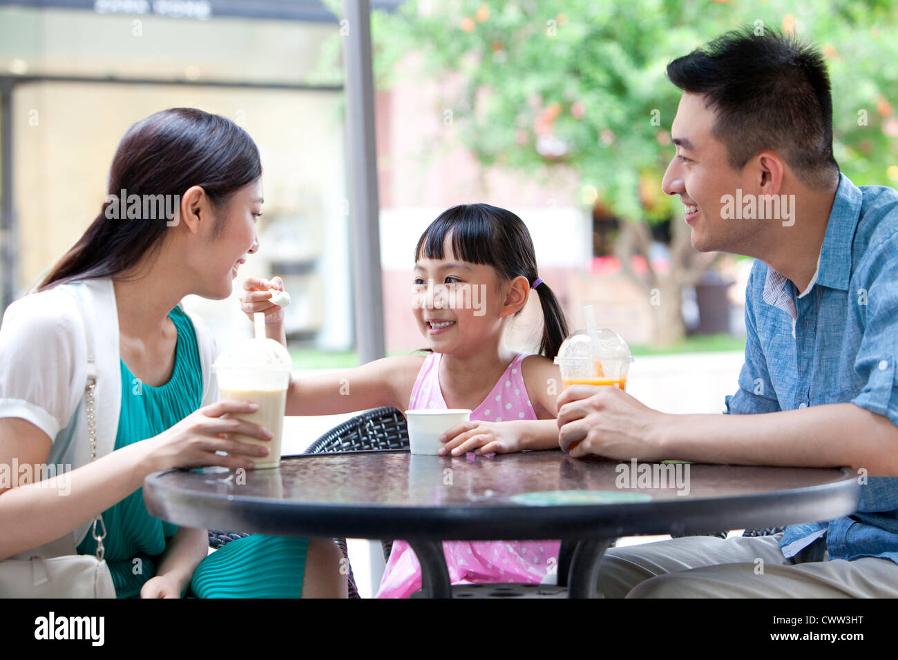 Family enjoying cold drink together Stock Photo - Alamy