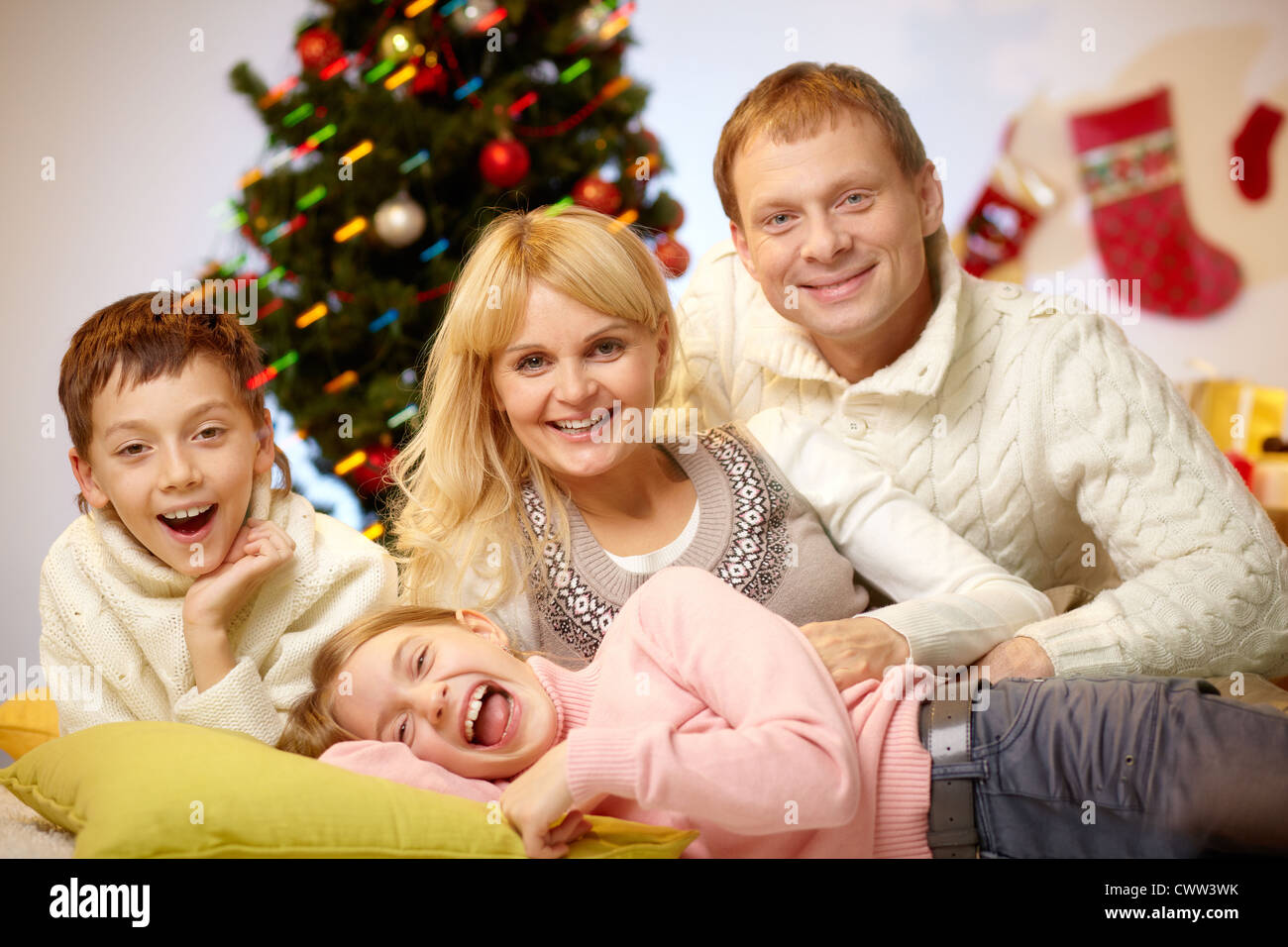 Portrait of four happy family members at home on Christmas Eve Stock ...
