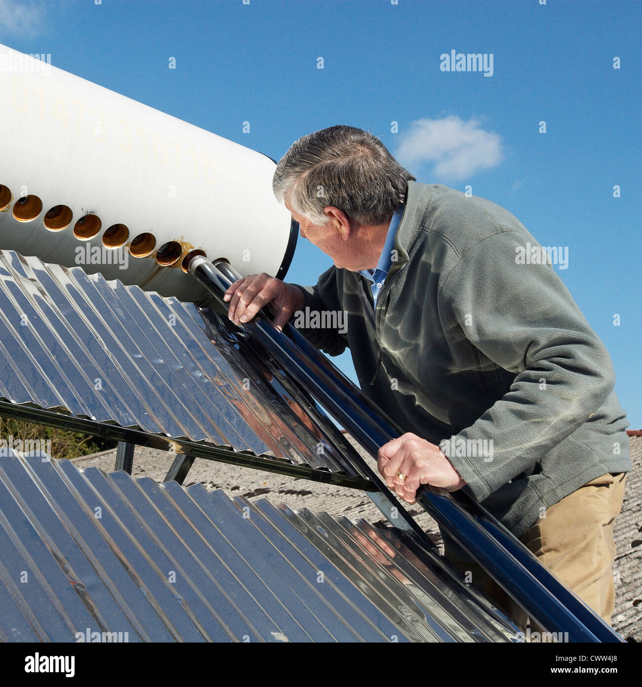 Inserting a solar panel tube to a frame Stock Photo - Alamy