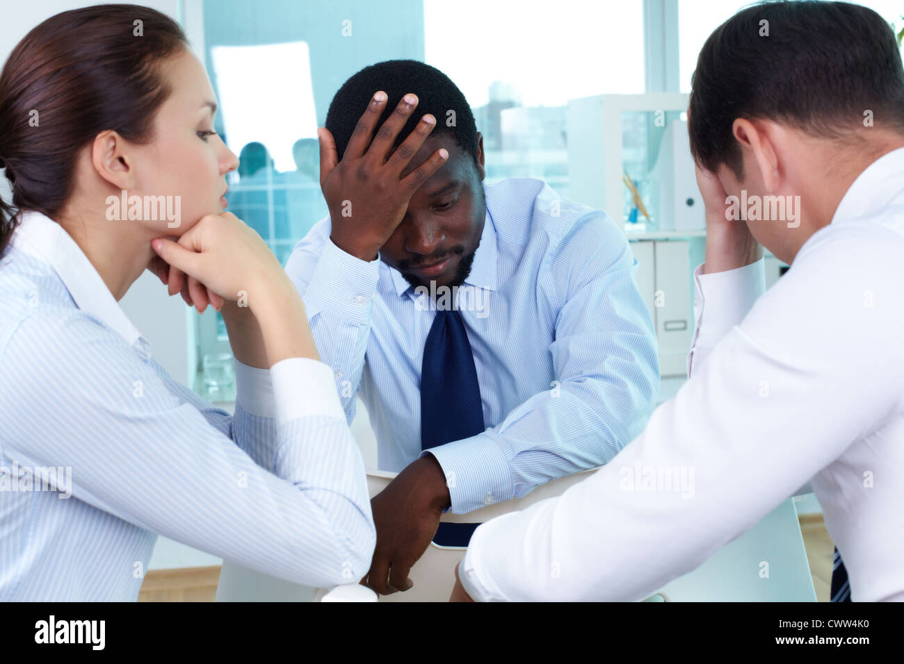 Portrait of sad business team sitting in office Stock Photo - Alamy