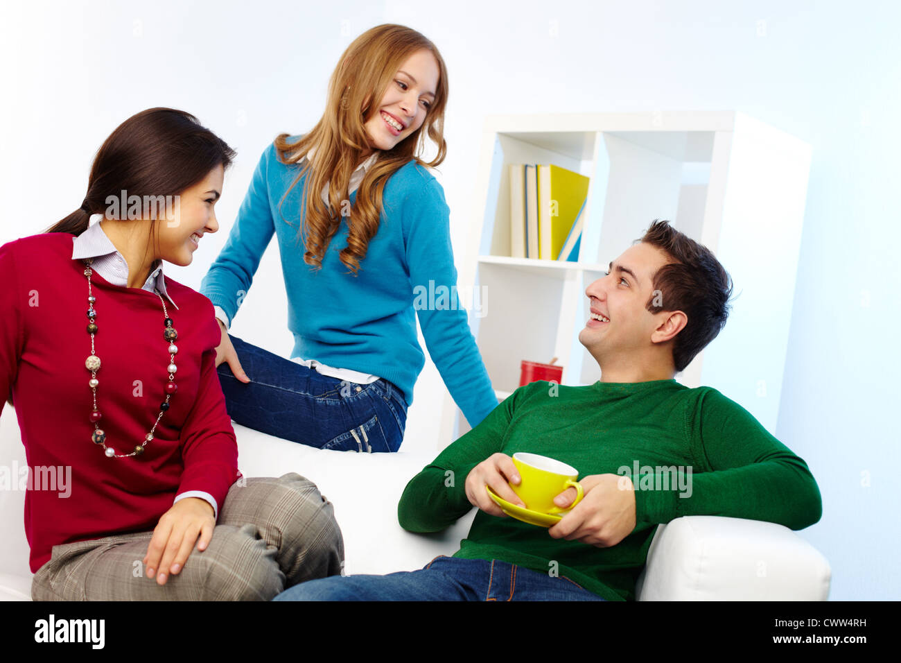 Portrait of joyful friends chatting at home Stock Photo - Alamy