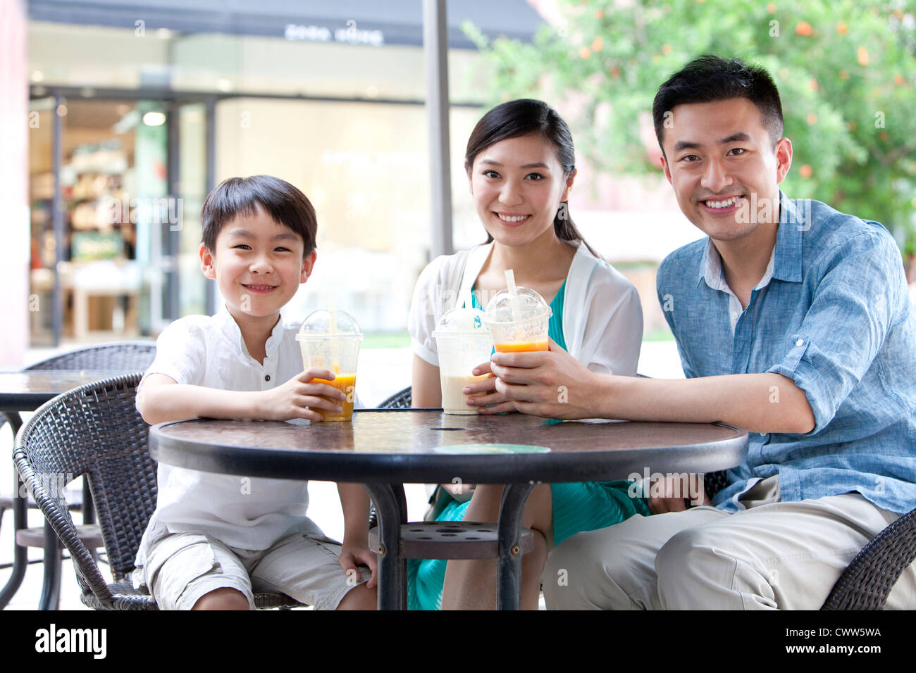 Family enjoying cold drink together Stock Photo - Alamy