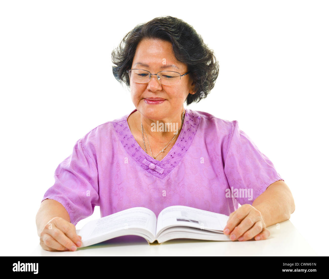 Asian senior woman serious reading book over white background Stock ...