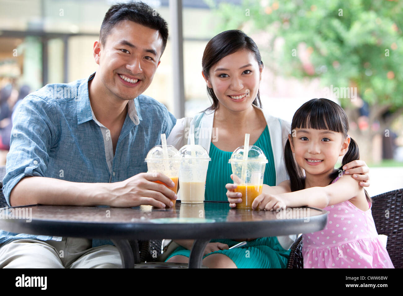 Family enjoying cold drink together Stock Photo - Alamy