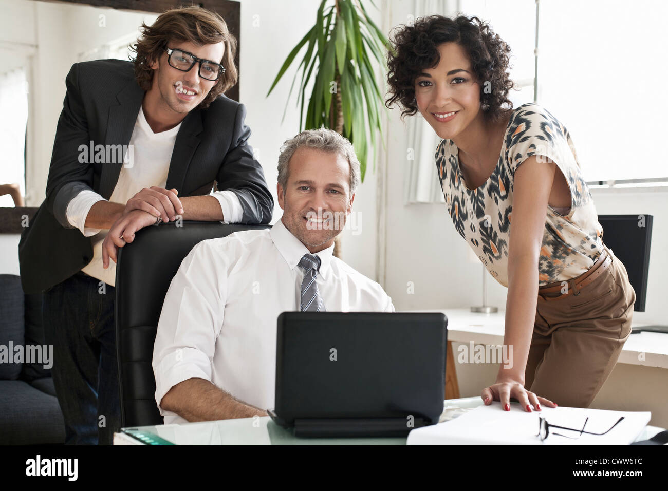 Business people smiling at desk Stock Photo - Alamy