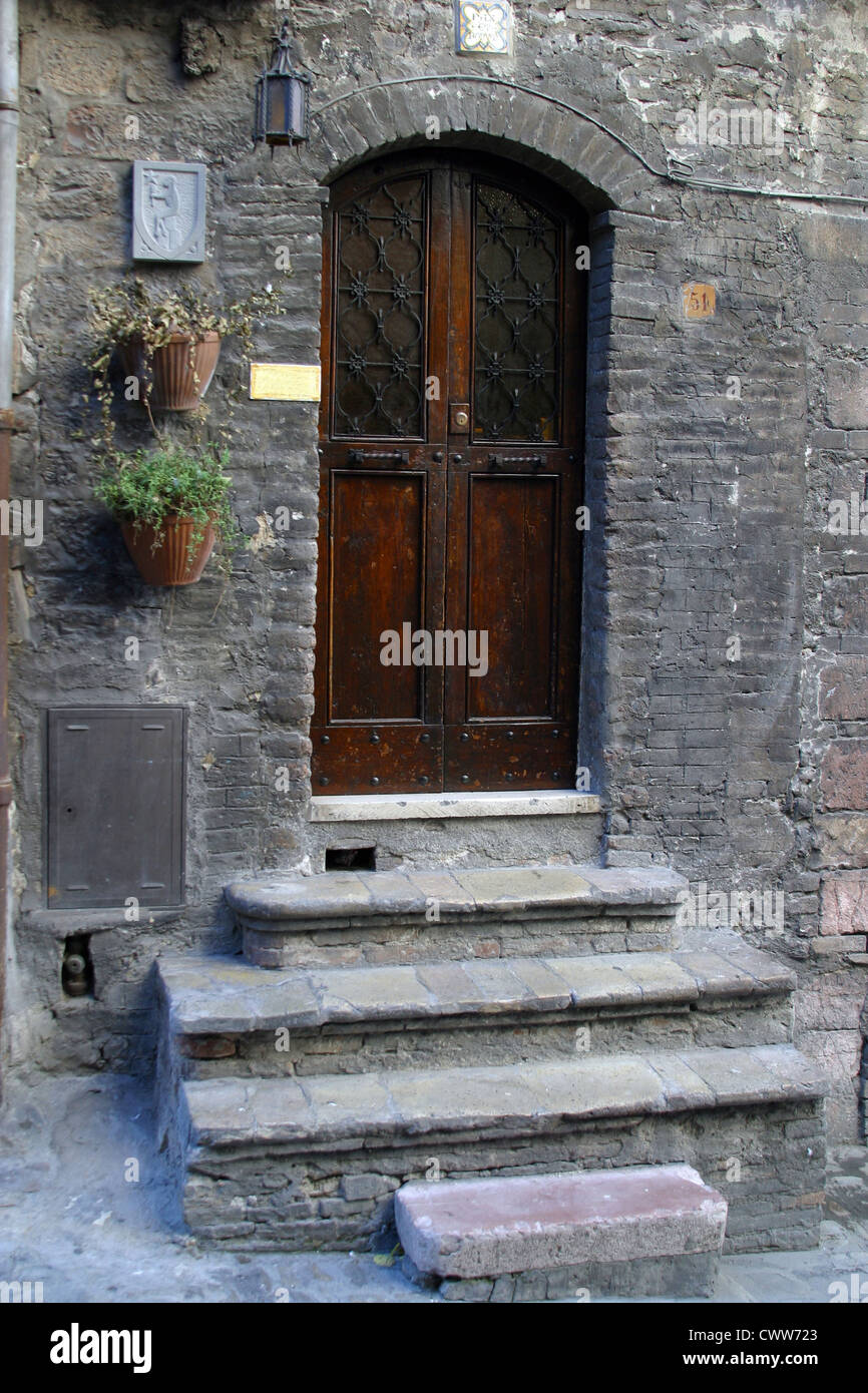 Wooden door with a stone door frame Stock Photo - Alamy